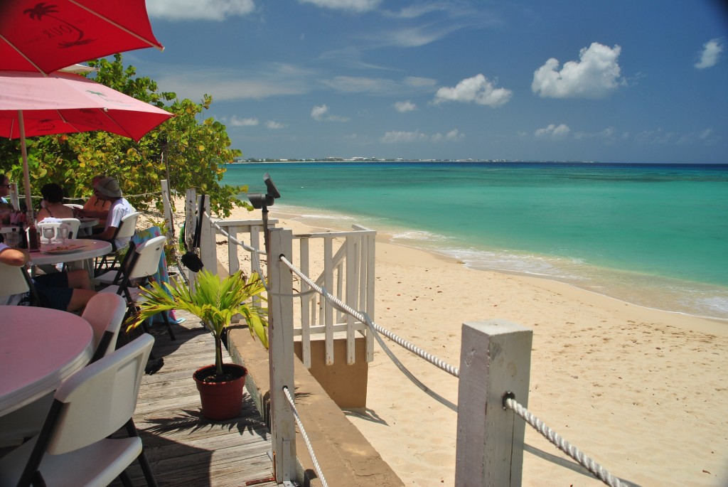 The tables on the deck right along Seven Mile Beach